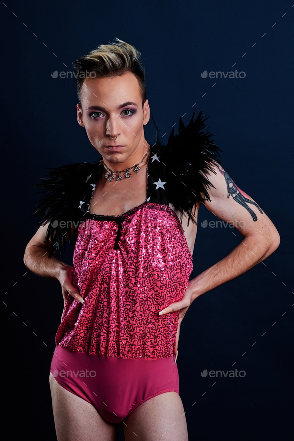young transgender model with pink dress and dark blue background Stock ...