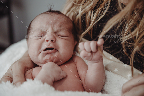 newborn with angry expression showing unpleasant grimaces Stock Photo ...