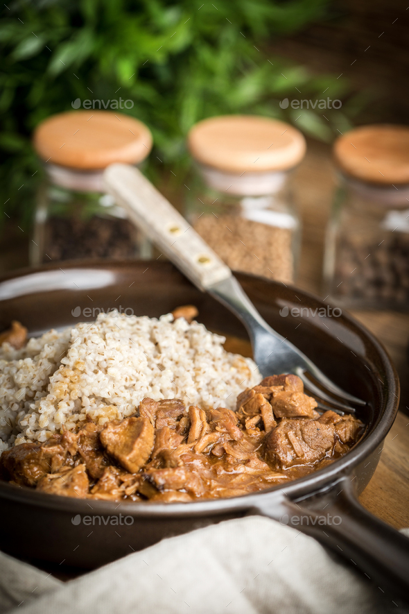 Barley groats with stewed meat. Stock Photo by foto_pstryki | PhotoDune