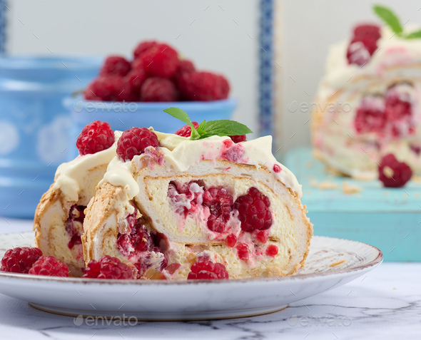 Baked meringue roll with cream and fresh red raspberry, white ...
