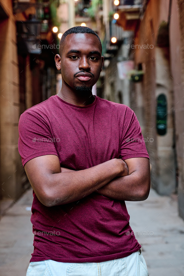 portrait of young black man looking directly to camera in outdoor ...