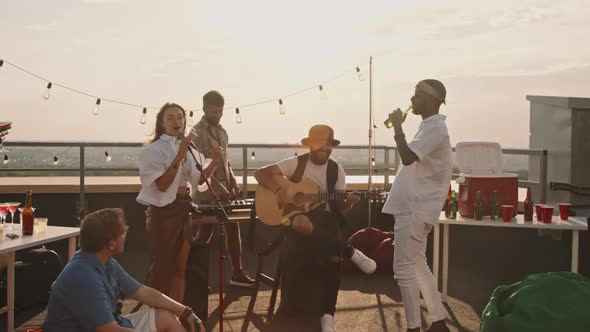 Musicians Playing at Rooftop Party, Stock Footage | VideoHive