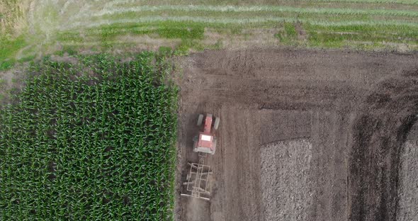 Farmer Tilling Soil At The Farm Field With Agricultural Tractor, Stock ...