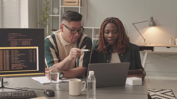 Multiethnic Couple of Programmers Developing Software in Office, Stock ...