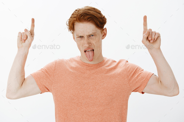 Hate rainy days. Portrait of moody displeased cute ginger guy with ...