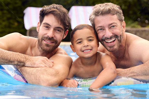 Portrait Of Same Sex Family With Two Dads And Son On Holiday In Swimming Pool Together Stock ...