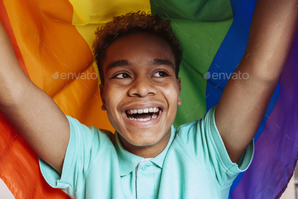 Homosexual man covered with rainbow flag over his head Stock Photo by ...