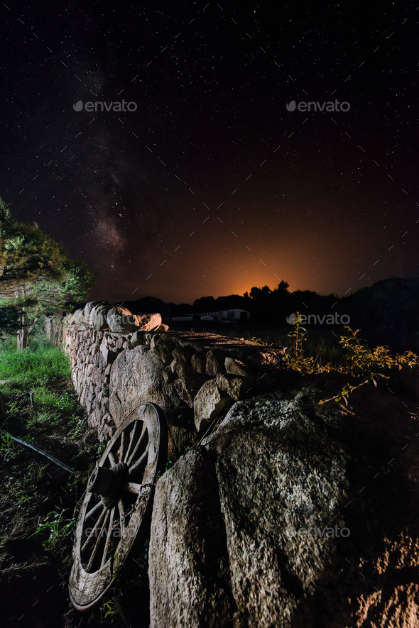 Rural night scene with starry sky and Milky Way Stock Photo by Raul_Mellado
