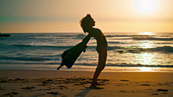 Silhouette flexible woman bending body backward standing sand beach at ...