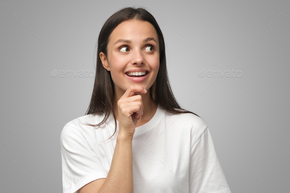 Portrait of pretty young female with dreamy cheerful expression ...