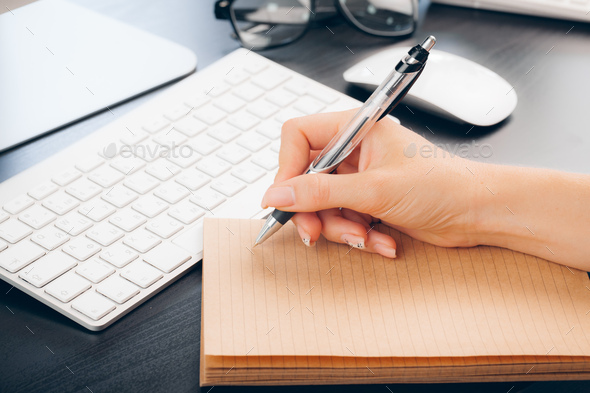 Pen and notebook up close on an office desk Stock Photo by FabrikaPhoto