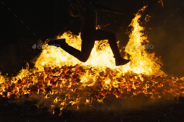 Summer solstice celebration jumping into the fire. Burning flames Stock ...
