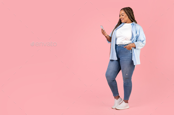 Black Woman Texting On Cellphone And Browsing Internet, Pink Background ...