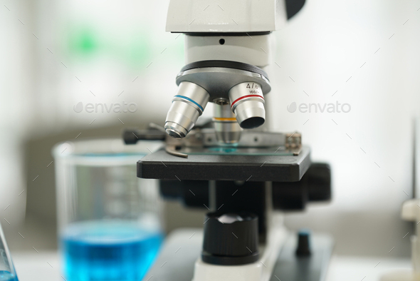 Microbiologist observing a microscopic specimen under the microscope ...