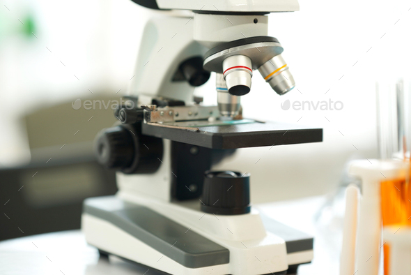Microbiologist observing a microscopic specimen under the microscope ...