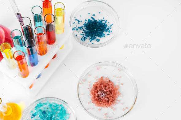 Colored liquids inside lab glassware on white table in laboratory Stock ...