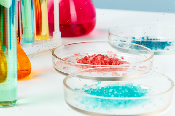 Colored liquids inside lab glassware on white table in laboratory Stock ...