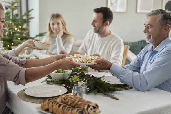 Senior man people sharing a plate with traditional Polish dumplings ...