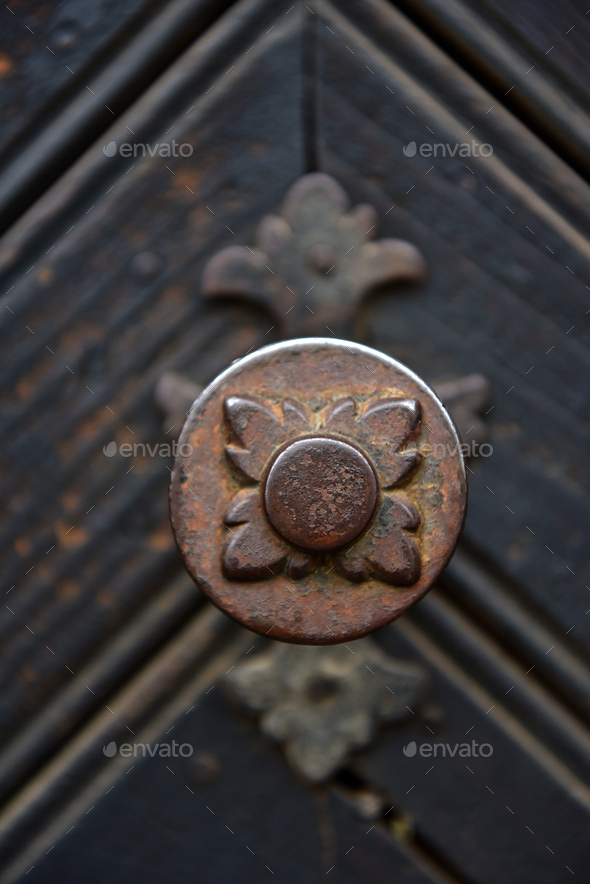 Rusty iron door knob on vintage wooden door Stock Photo by salajean