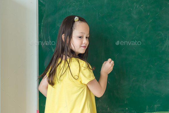 Kid write on chalk board. Back to school. Schoolchild in class. Happy ...
