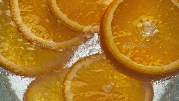 Closeup oranges fizzy water in light background. Refreshing citrus ...