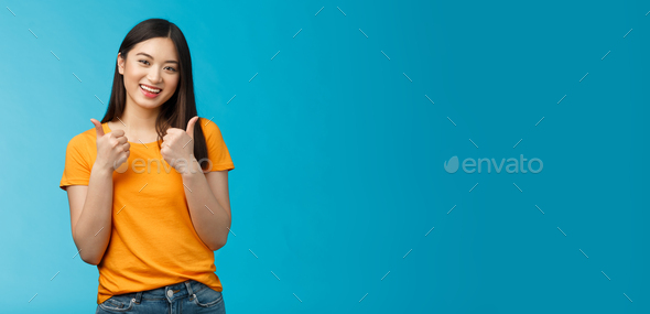 Supportive cute friendly asian girl give thumbs up and smiling ...