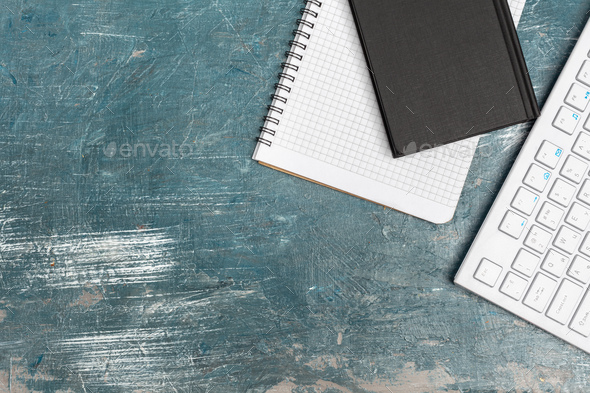 Office table with note paper, computer keyboard and supplies close up ...