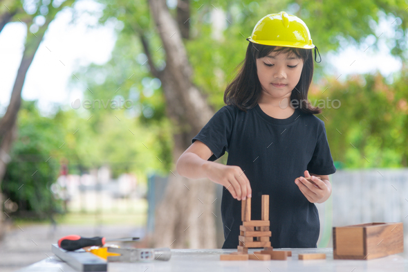 Asian girl children playing as an engineer helmet are smiling and happy ...