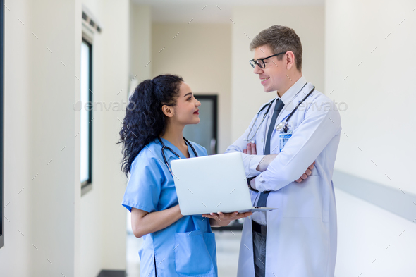 Clinicians in uniform standing and looking of computer monitor, Stock ...