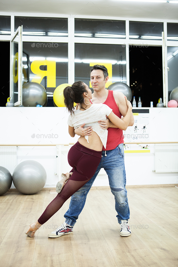 Dancing partners making poses on kizomba rhythm Stock Photo by DC_Studio
