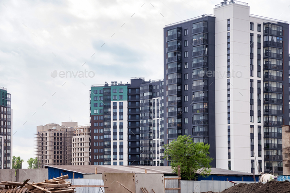 Construction site with new and unfinished residential buildings on sky ...
