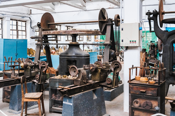 Interior of an old metalworking factory with metal lathes and presses ...