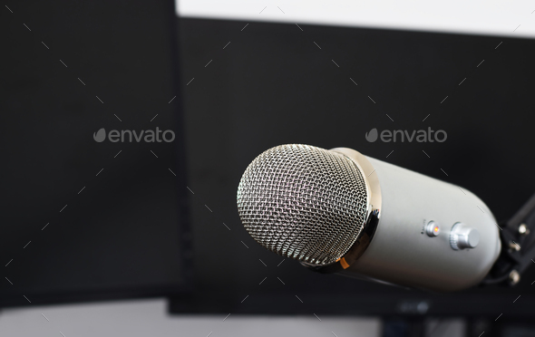 Microphone in front of black computer screens Stock Photo by JulieAlexK