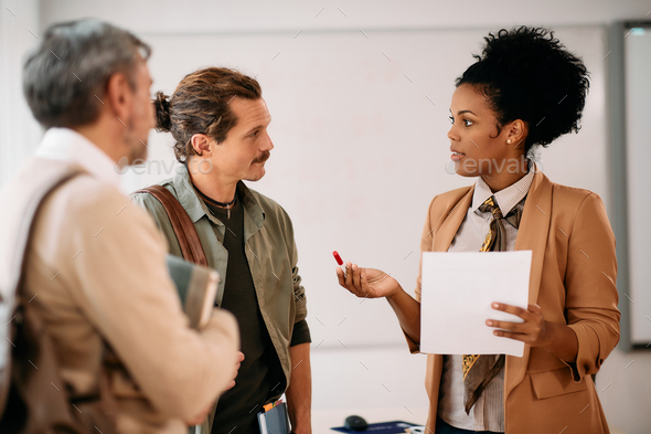 African American professor explaining test results to her adult ...