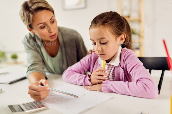 Small girl studying math with her mother while learning at home. Stock ...