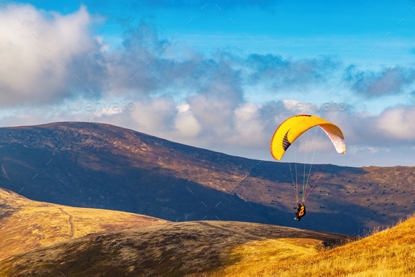 People try paragliding flying with parachutes against clouds Stock ...