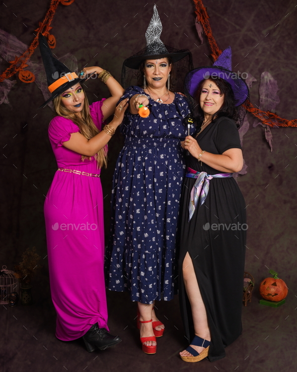 Studio portrait of three women of different ages dressed as witches ...