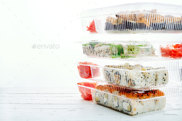 Stack of plastic boxes with sushi roll sets. Food delivery Stock Photo ...