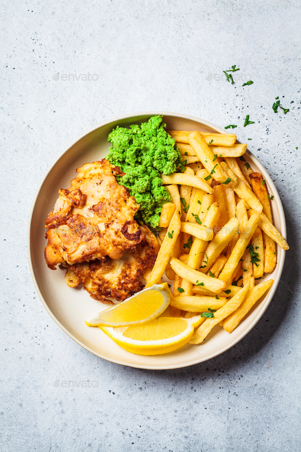 Fish and chips. Cod fish in batter with french fries and mashed peas ...