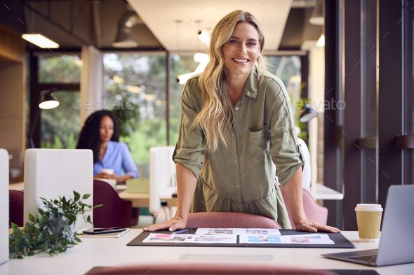Businesswoman Standing At Desk In Open Plan Office Approving Or ...
