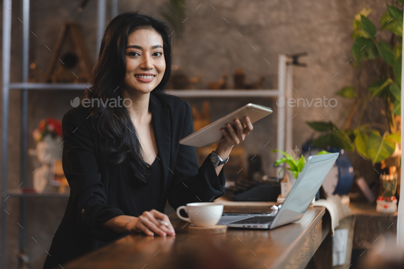 Professional Asian business woman using computer laptop to work on ...