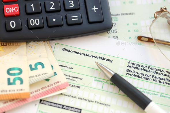 German income tax return form with pen and european euro money bills ...