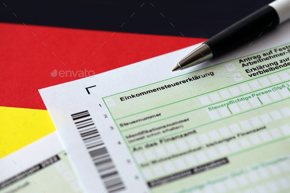 German annual income tax return declaration form with pen on flag close ...