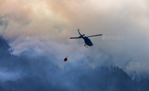 Wildfire Service Helicopter flying over BC Forest Fire and Smoke on the ...