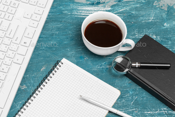 Office table with note paper, computer keyboard and supplies close up ...