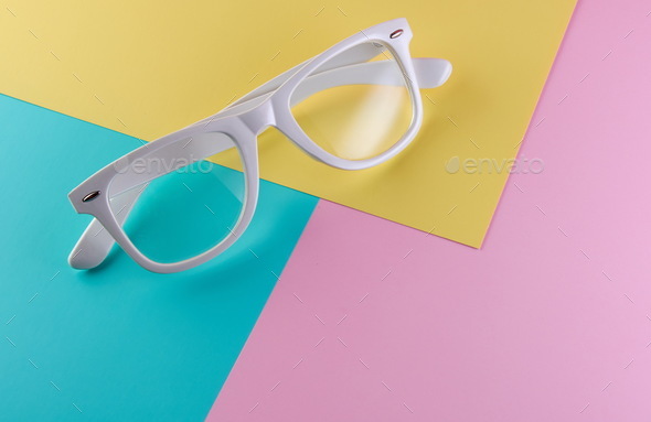 White Glasses On A Color Background Top View Trendy Minimal Style With Colorful Paper Backdrop