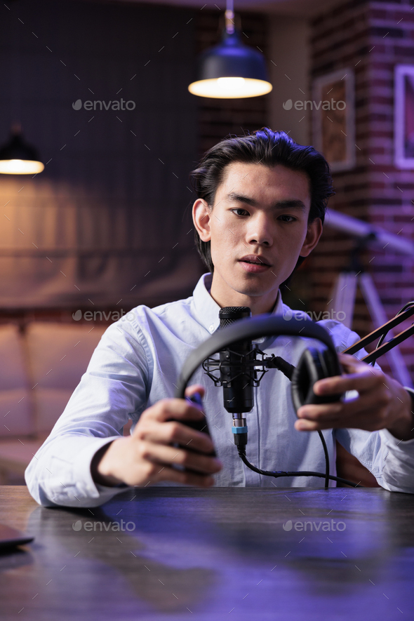 Asian influencer filming review video on camera Stock Photo by DC_Studio