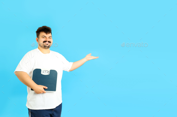 Concept of weight loss, young fat man on blue background Stock Photo by ...