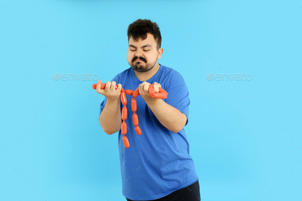 Concept of weight problems, young fat man on blue background Stock ...