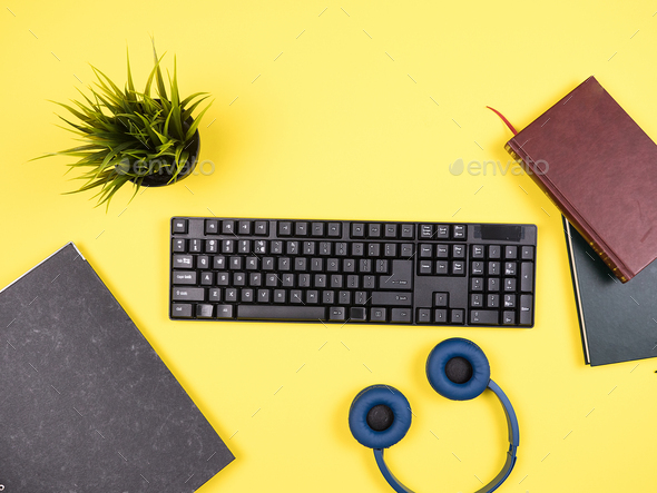 Top view of keyboard, folder and headphones Stock Photo by DC_Studio